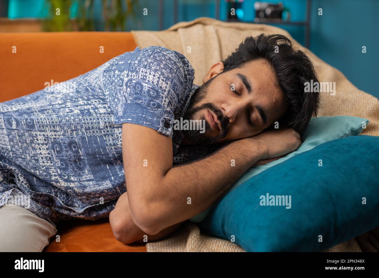 Tired indian man lying down in bed taking a rest. Carefree young hindu ...