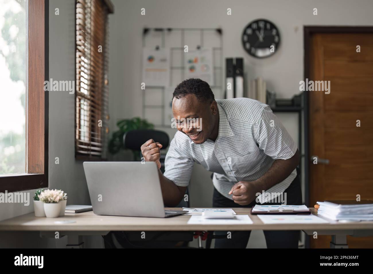 African man celebrating reading documents hi-res stock photography and ...
