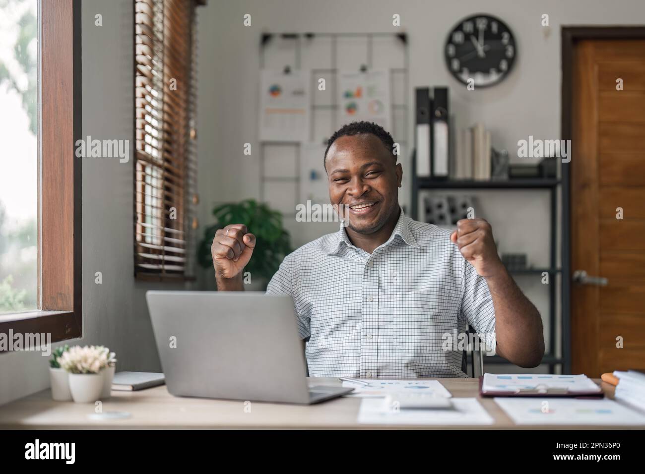 Happy surprised African American businessman reading good news in ...