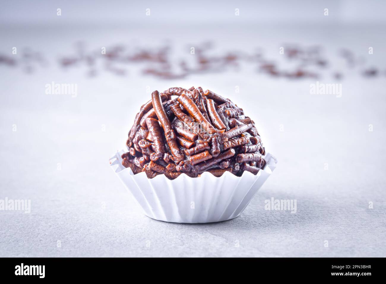 Brigadeiro candy in a white shape on a white background with chocolate ...