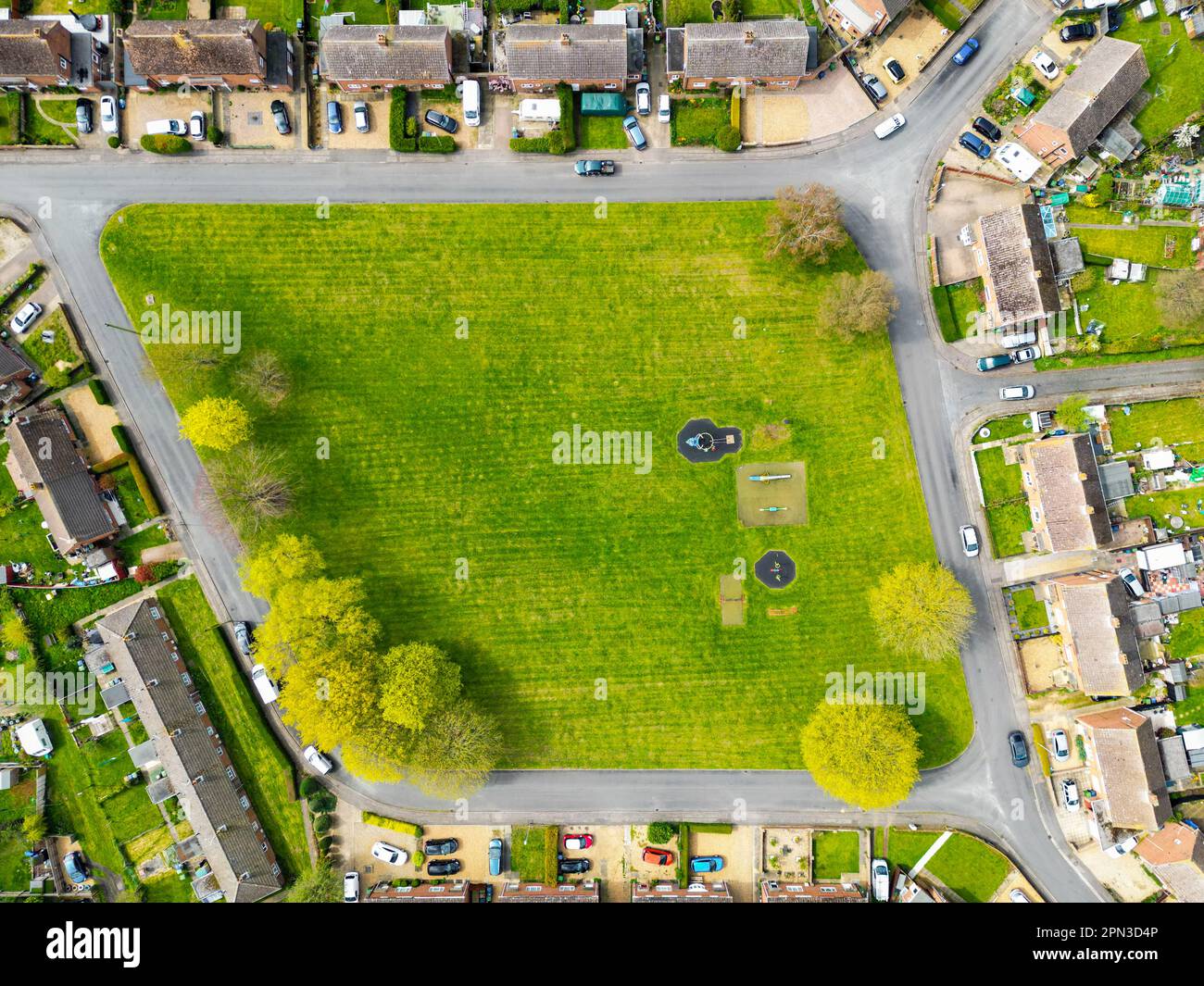 Aerial top down view of a centre green space area and small playground ...