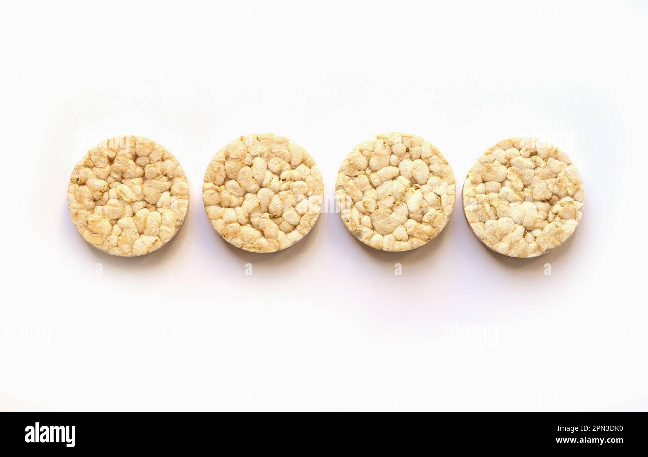 Group of healthy puffed rice cakes isolated on white. Space for text ...