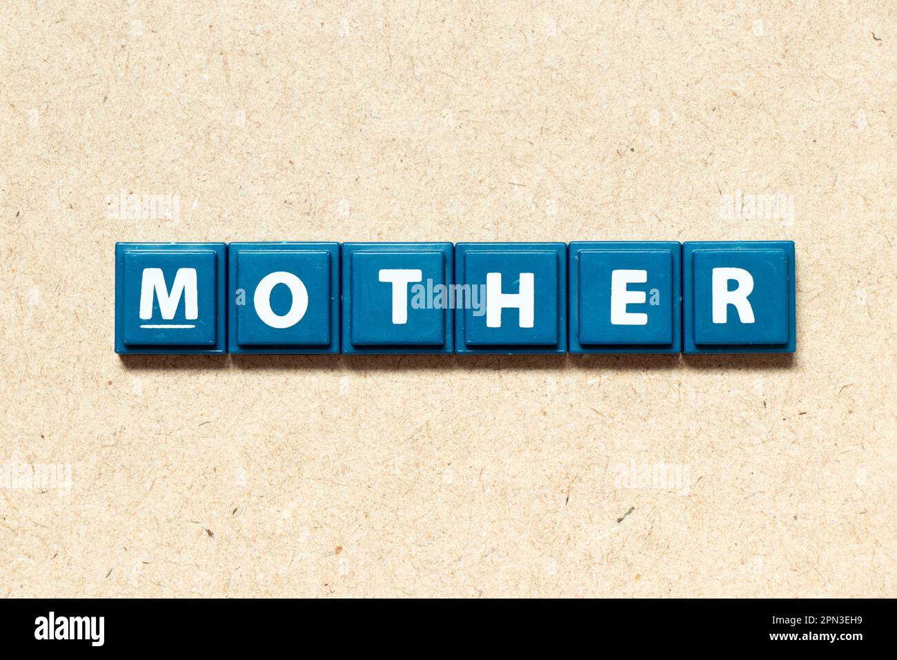 Tile alphabet letter in word mother on wood background Stock Photo - Alamy