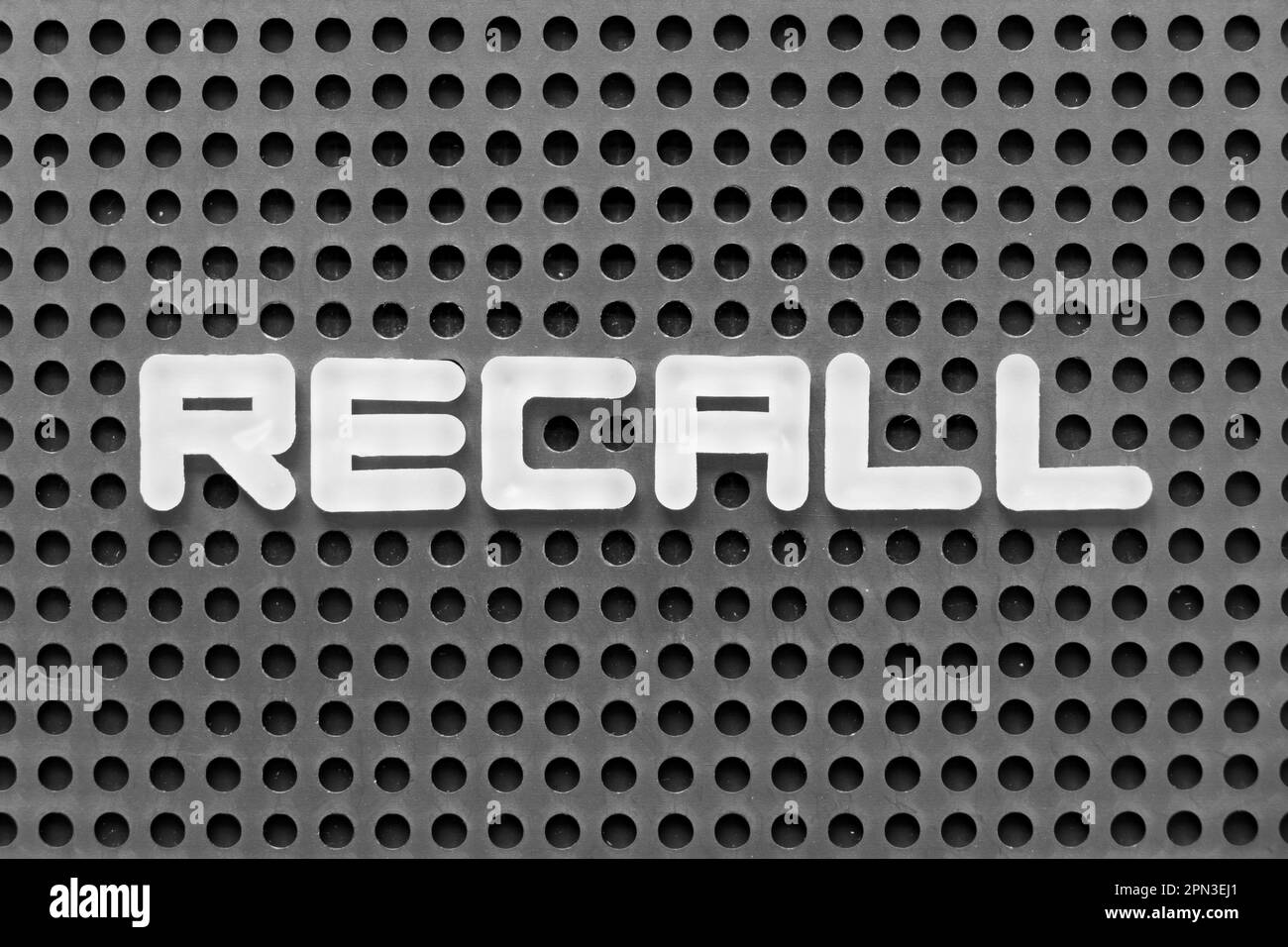 White alphabet letter in word recall on black pegboard background Stock ...