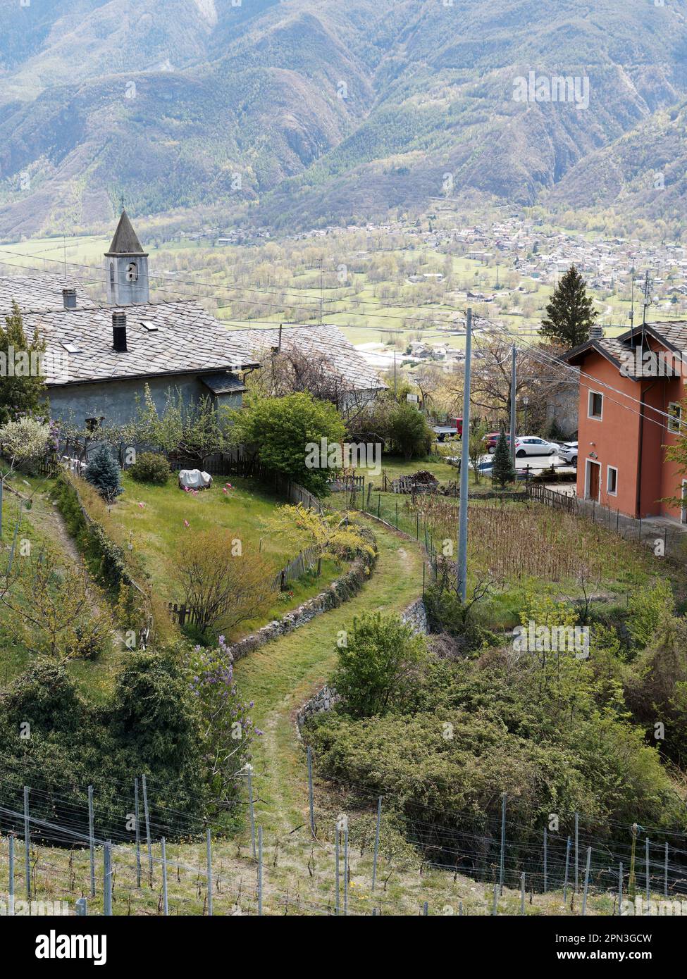 Rural landscape with a church and a house with a public path between ...