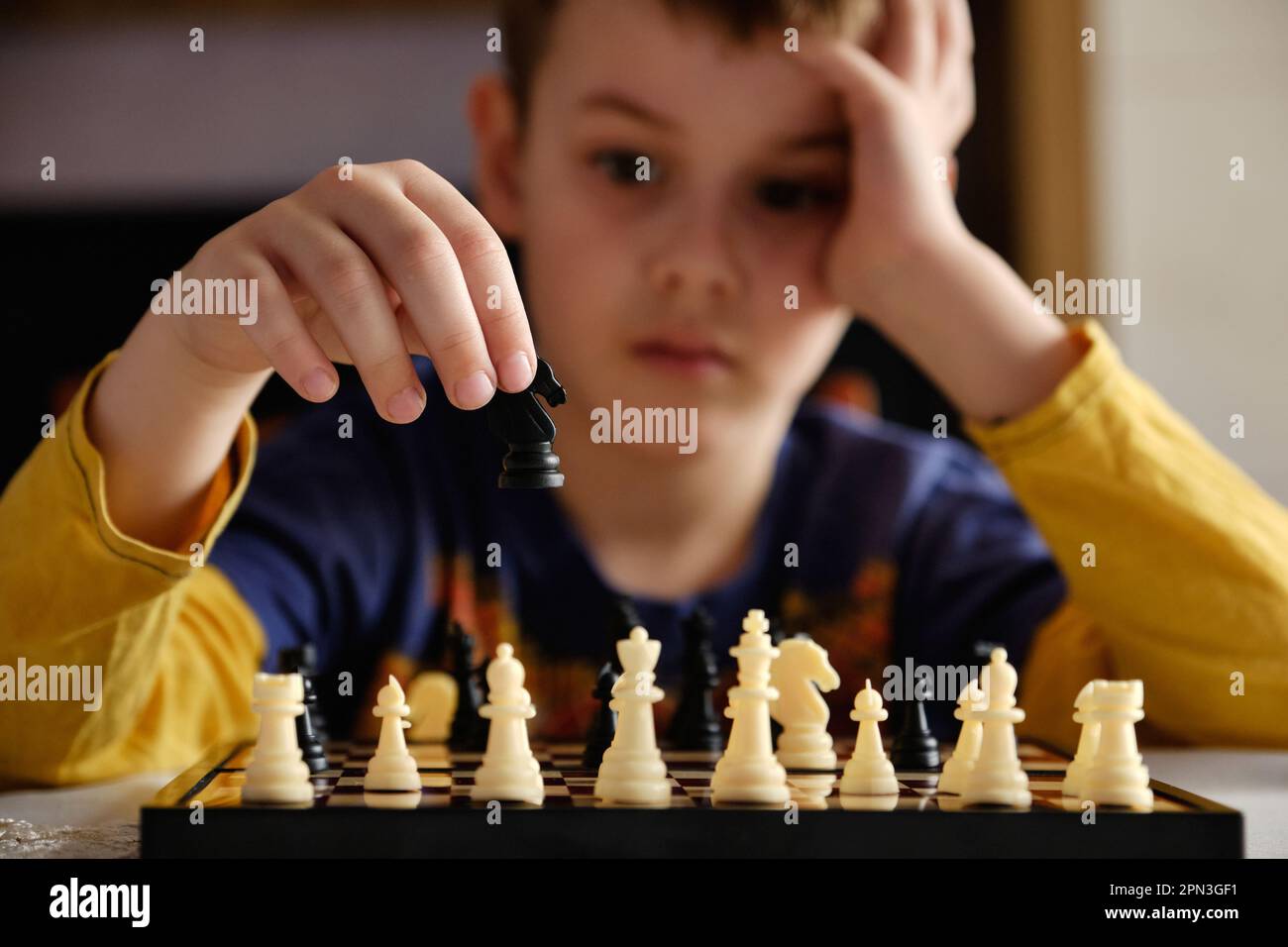 Cute little boy plays chess. Education concept, intellectual game ...