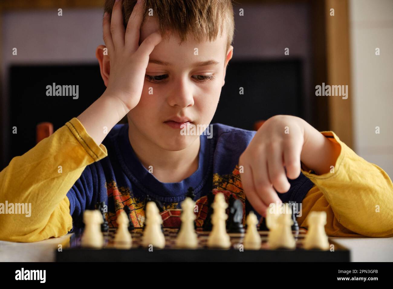 Cute little boy plays chess. Education concept, intellectual game ...