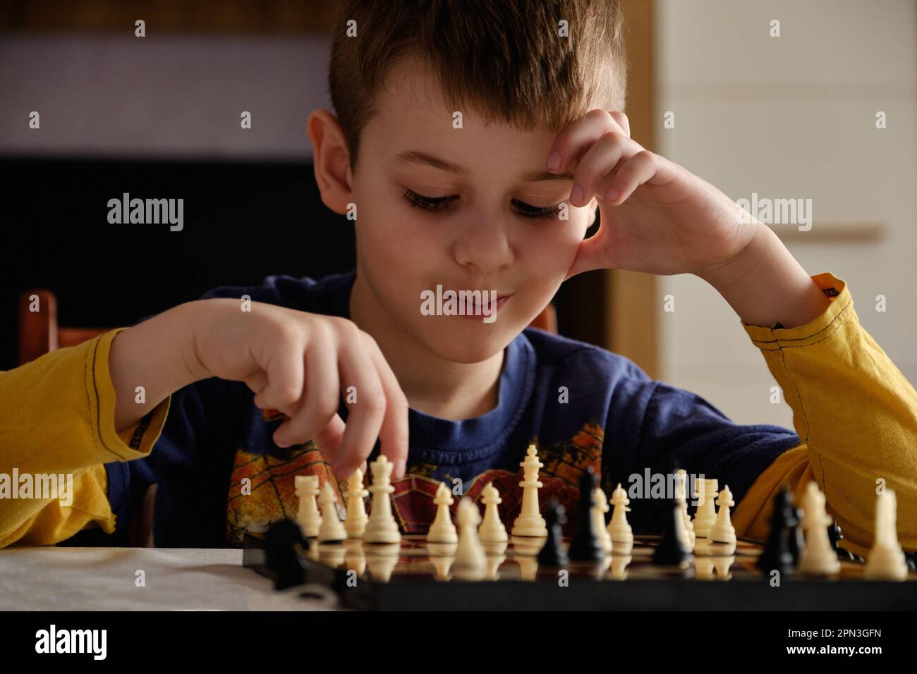 Cute little boy plays chess. Education concept, intellectual game ...