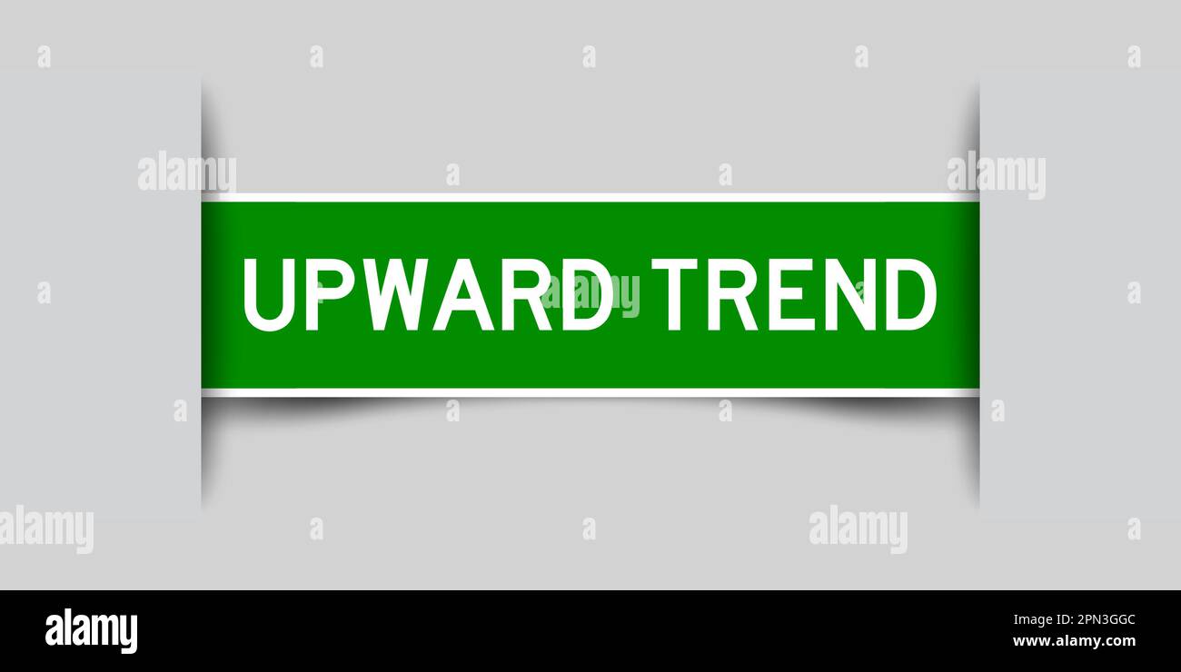 Inserted green color label sticker with word upward trend on gray ...