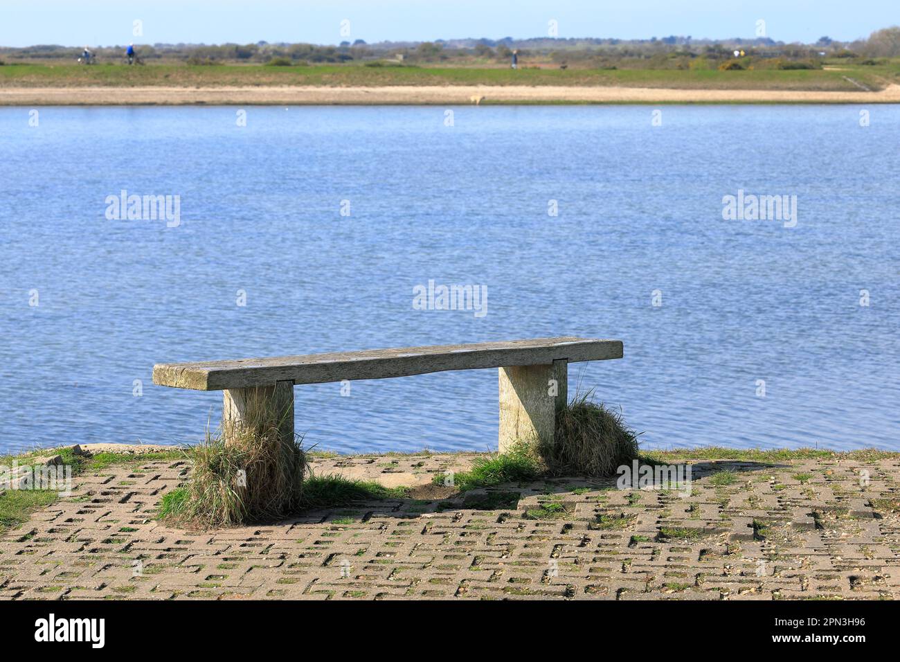 Empty wooden bench with a view over the sea to a beach Stock Photo - Alamy