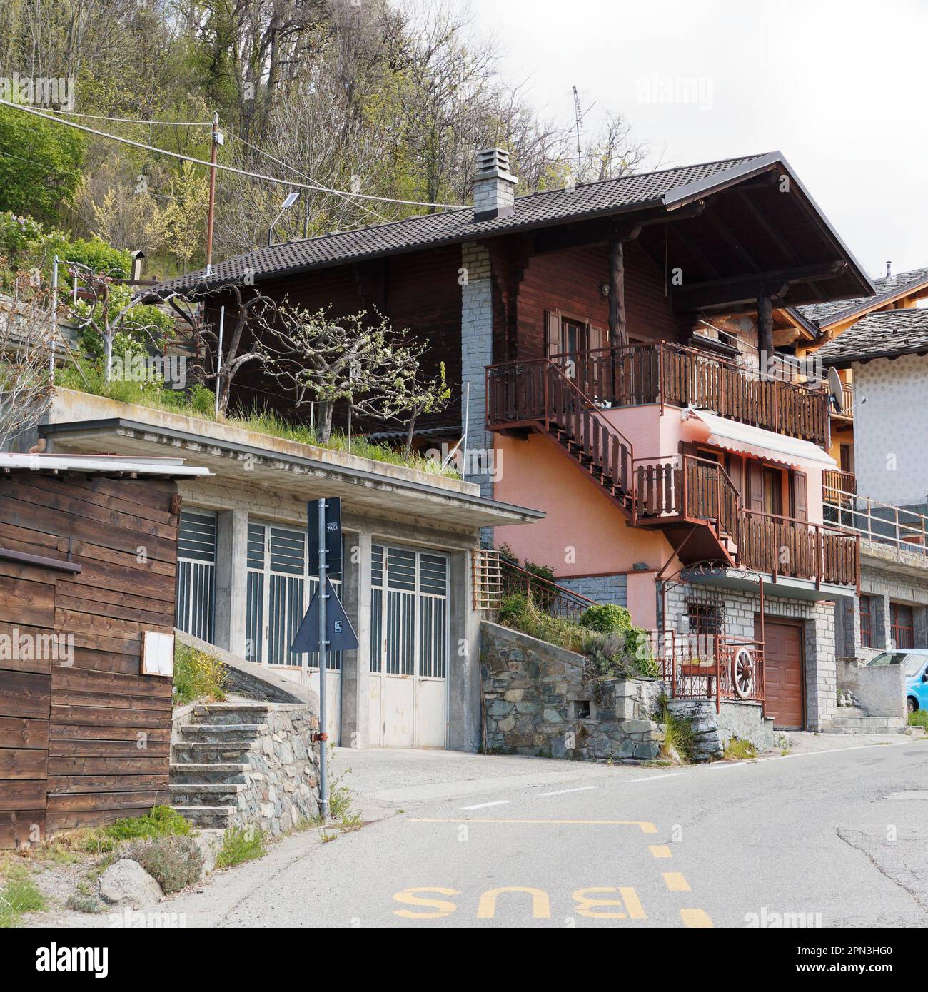 Stone and wood traditional building with garage nextdoor near Nus in ...