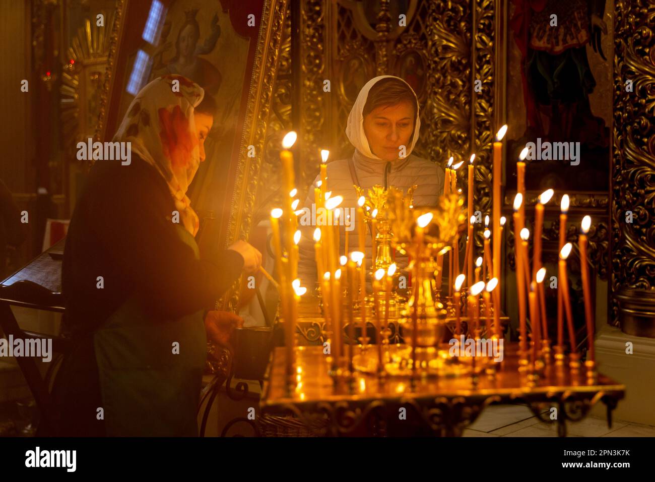 Ukrainian believers burn candles during the Holy Saturday celebrations ...