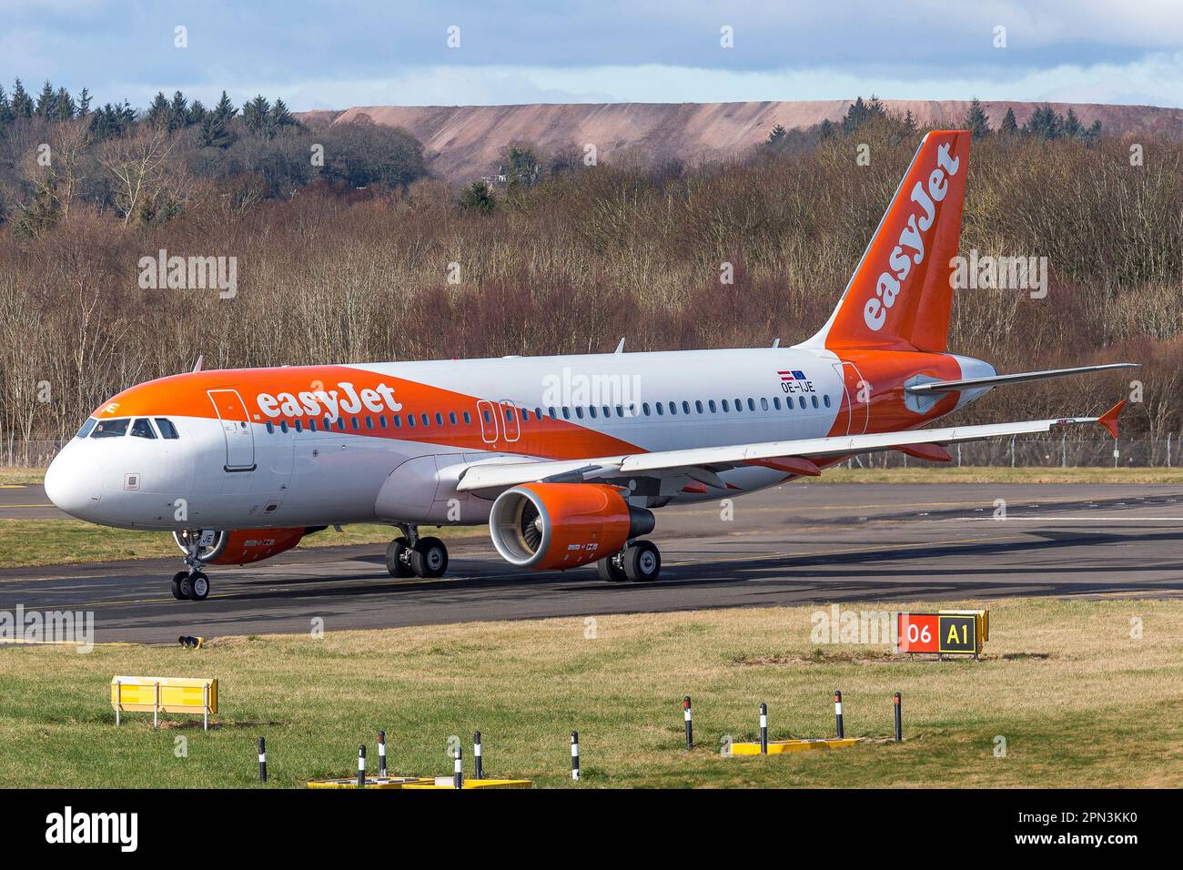 An orange Easyjet plane taking flight from an airport flight strip ...