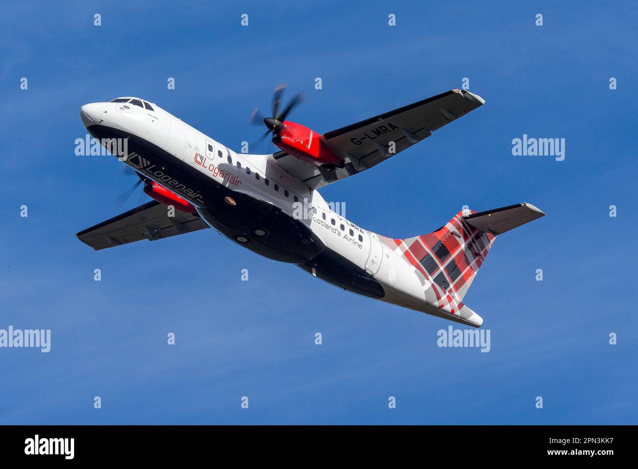 A large Loganair plane taking flight from an airport flight strip Stock ...