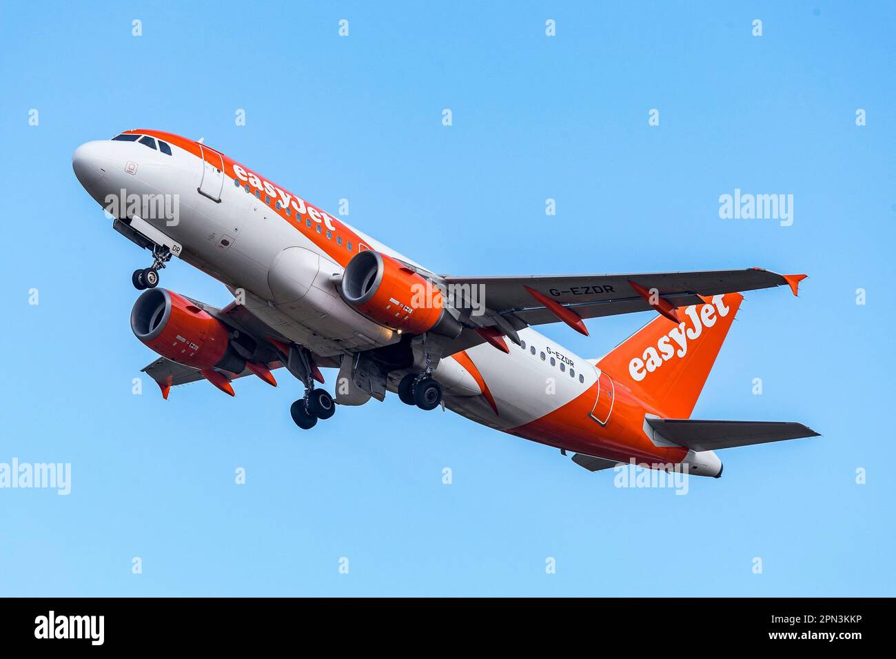 An orange Easyjet plane taking flight from an airport flight strip ...