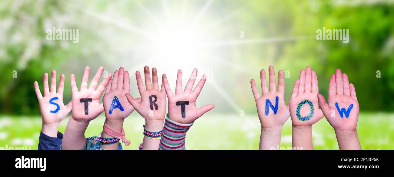 Children Hands Building Word Start Now, Grass Meadow Stock Photo - Alamy