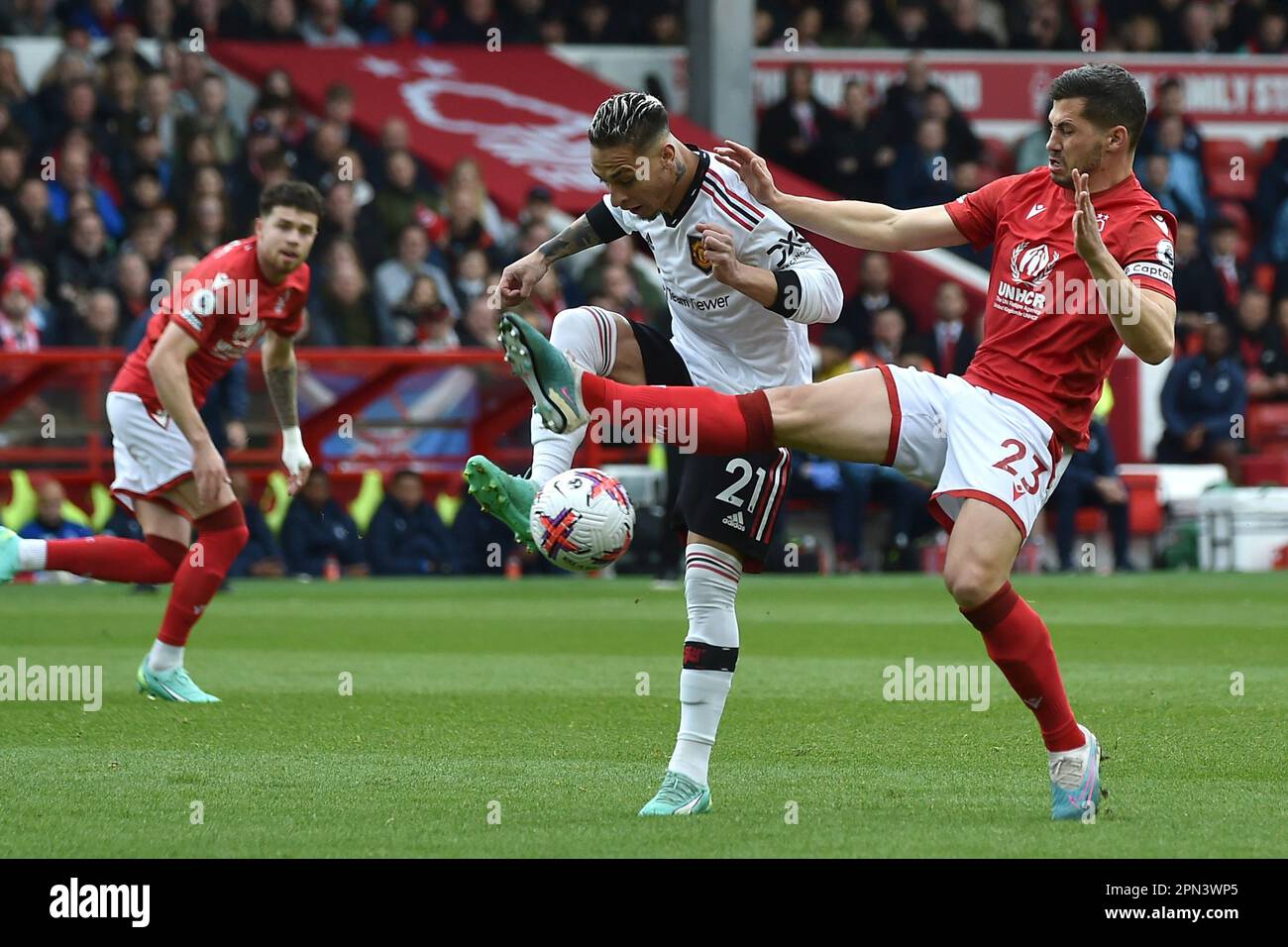 Manchester United's Anthony, centre, challenges for the ball with ...