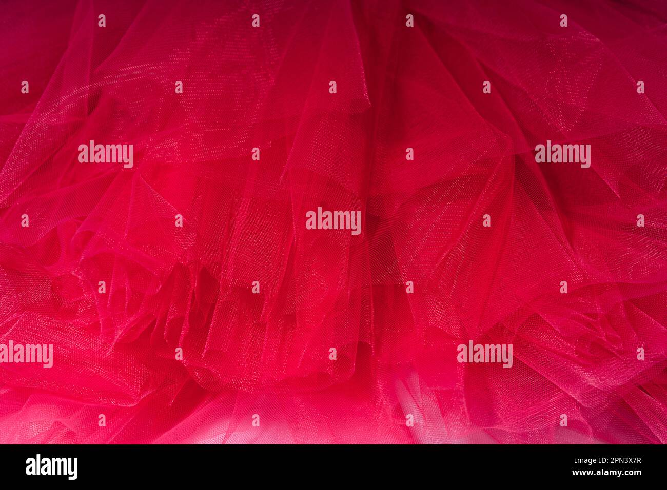 Red background of tulle fabric close-up Stock Photo - Alamy