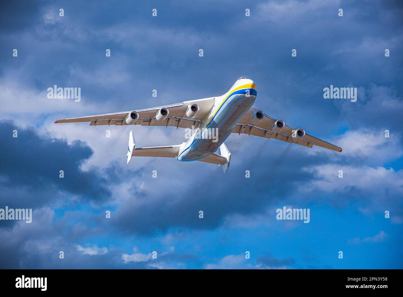 A large cargo plane flies in the blue sky. Aviation air transport ...