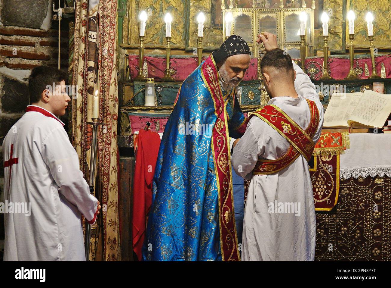 Priest Behnam Konutgan leads the mass at the Virgin Mary Church in ...