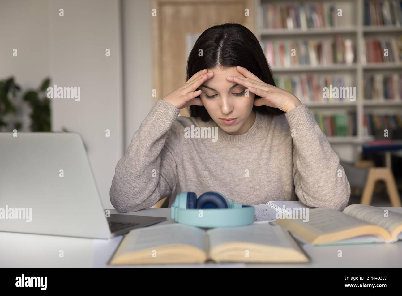 Student girl sit with textbooks learns home tasks looking tired Stock ...