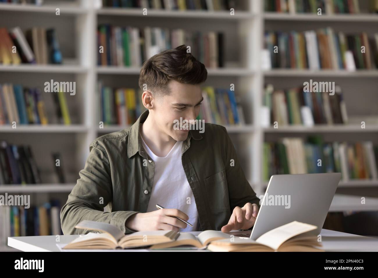 Student prepare assignment, learn theory, studying in library using ...