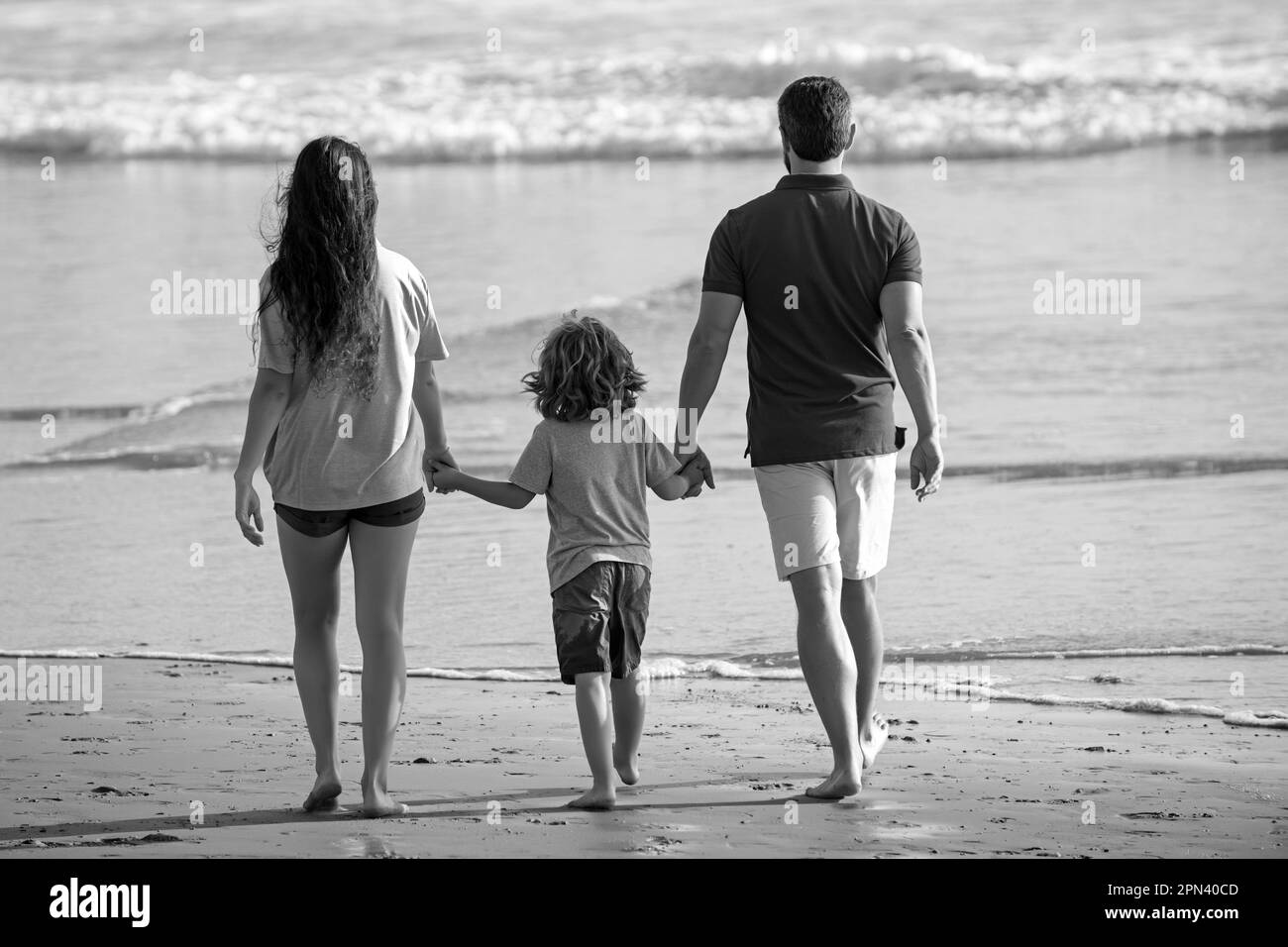 Mother and father and son back view Black and White Stock Photos ...