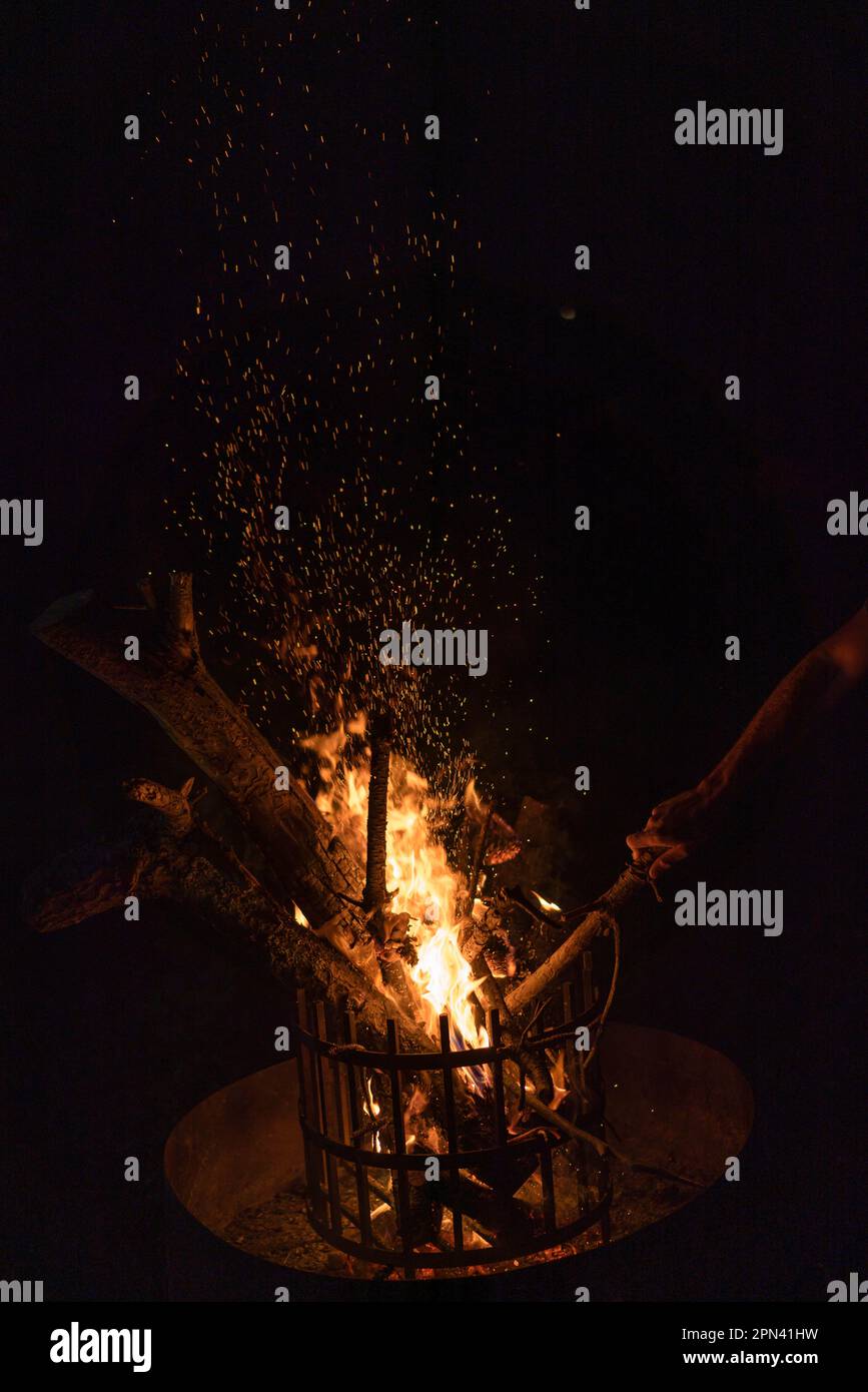 Bonfire with sparks flying around. Fire and camping Stock Photo - Alamy