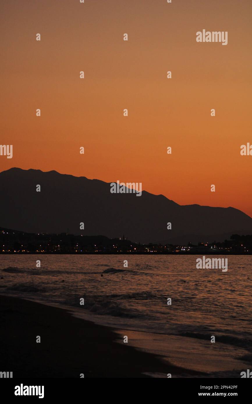 Sunset with mountains at the ocean in Crete Stock Photo - Alamy