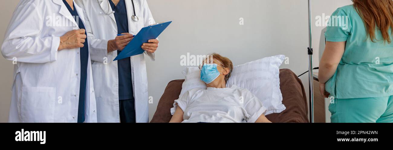 Professional doctors discuss over patient's diagnosis standing in ...