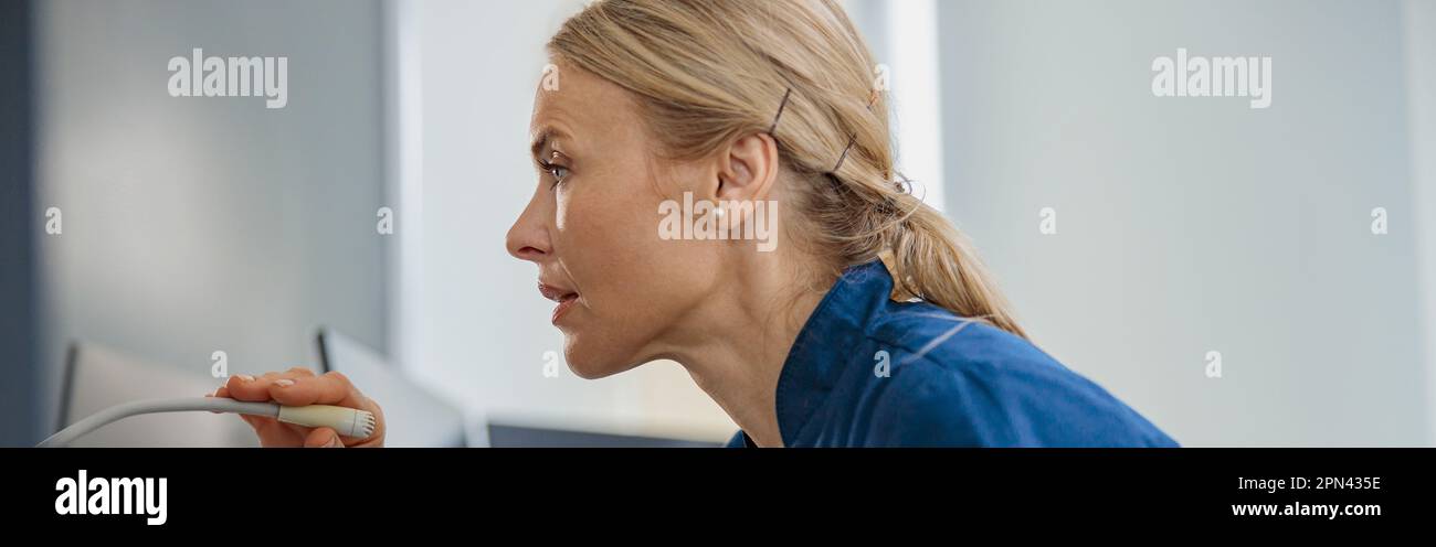 Nurse on Duty makes announcement into microphone sitting at Reception ...