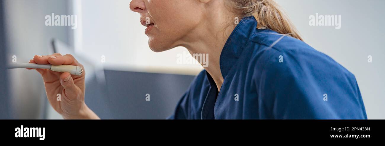 Nurse on Duty makes announcement into microphone sitting at Reception ...