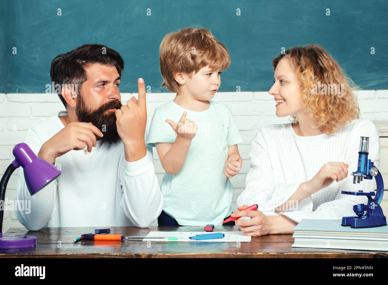 Mother father and son together schooling. Boy from elementary school ...