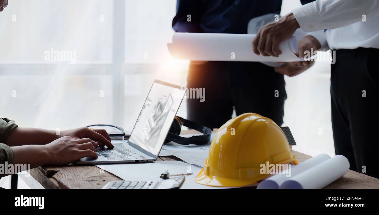 Architect and Engineer working with blueprints for architectural plan ...