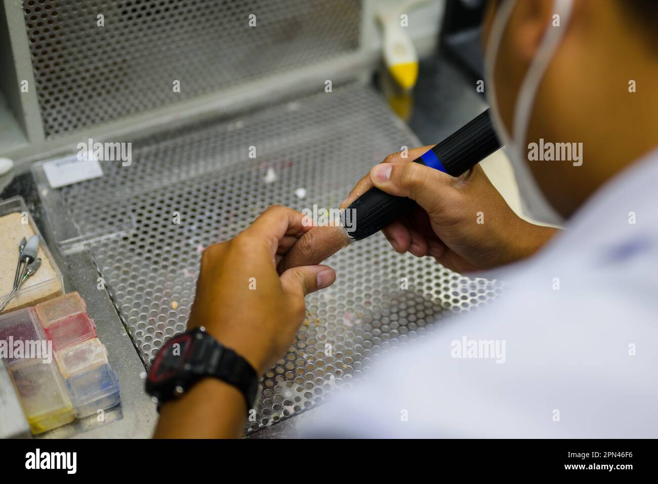 Technician making and checking prosthetic limb at prosthetic workshop ...