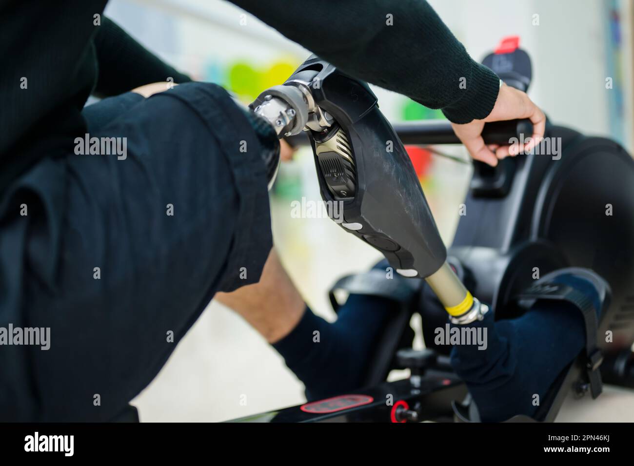Male patient with physical disability doing exercise routine indoor ...