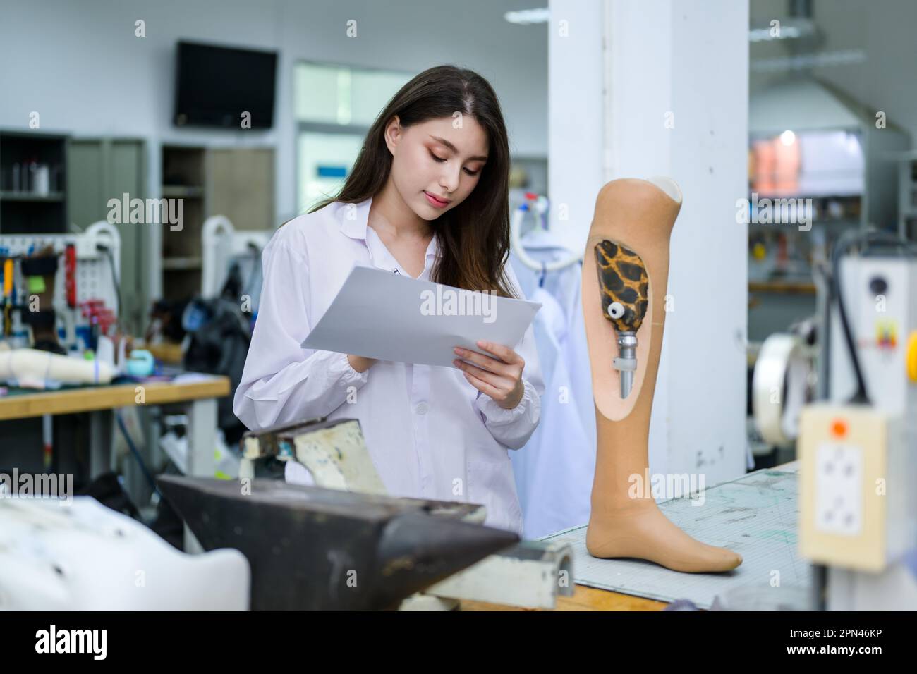 Prosthetic technician holding prosthetic leg checking and controlling ...