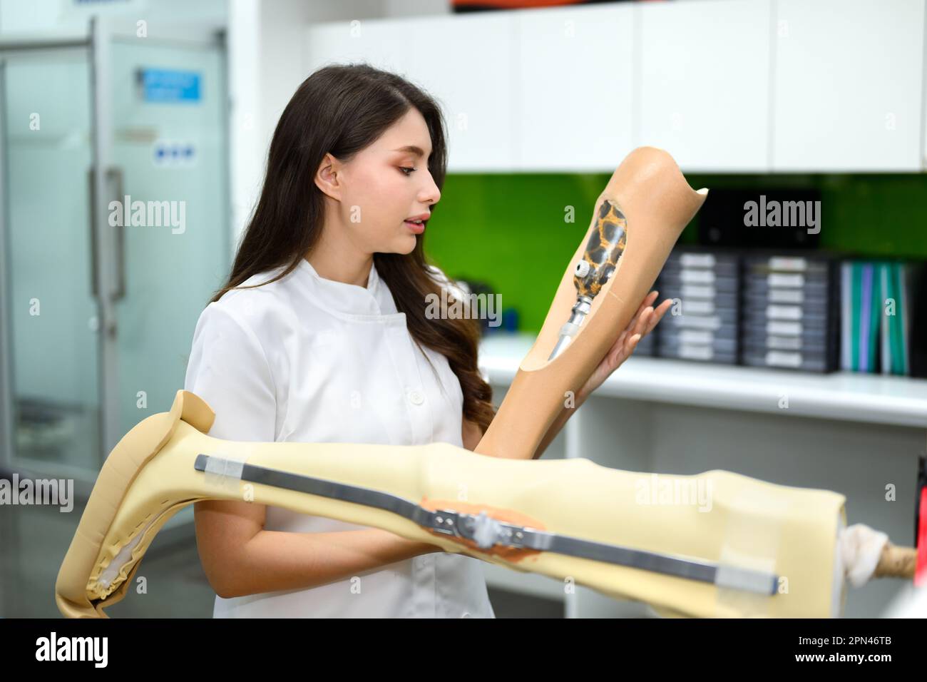 Technician making prototype of prosthetic leg, Artificial metal limb ...