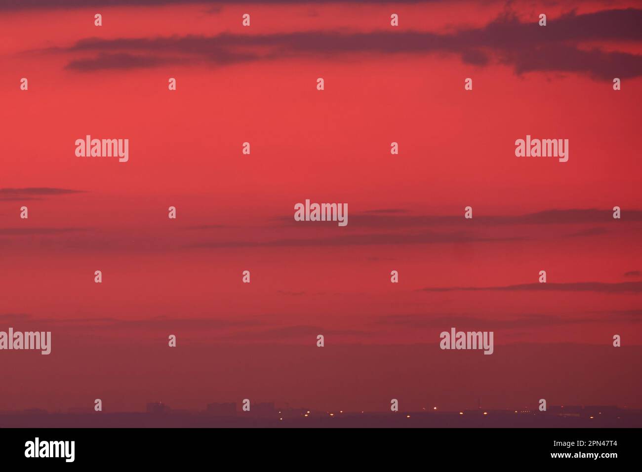 Sunset sky with red light of the setting sun. Evening clouds in the ...