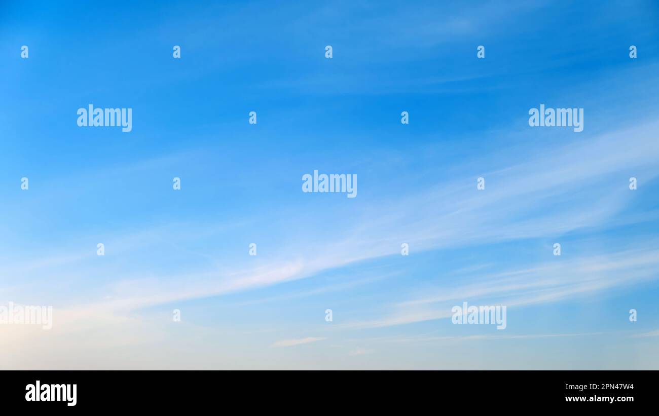 White cirrus and stratus clouds in a blue daytime sky Stock Photo - Alamy