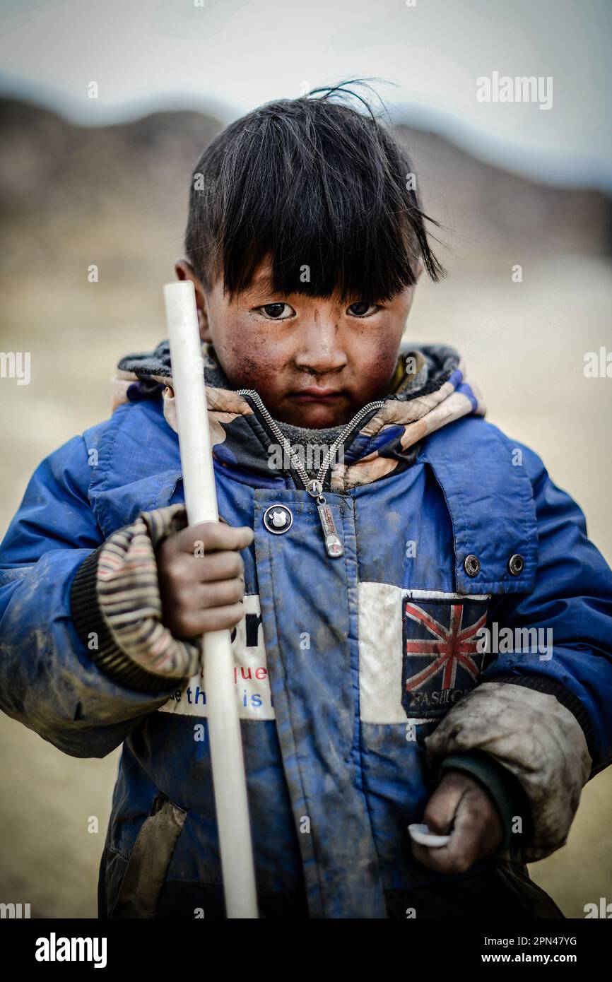 A young shepherd boy in a mountain village in Tibet, China Stock Photo ...
