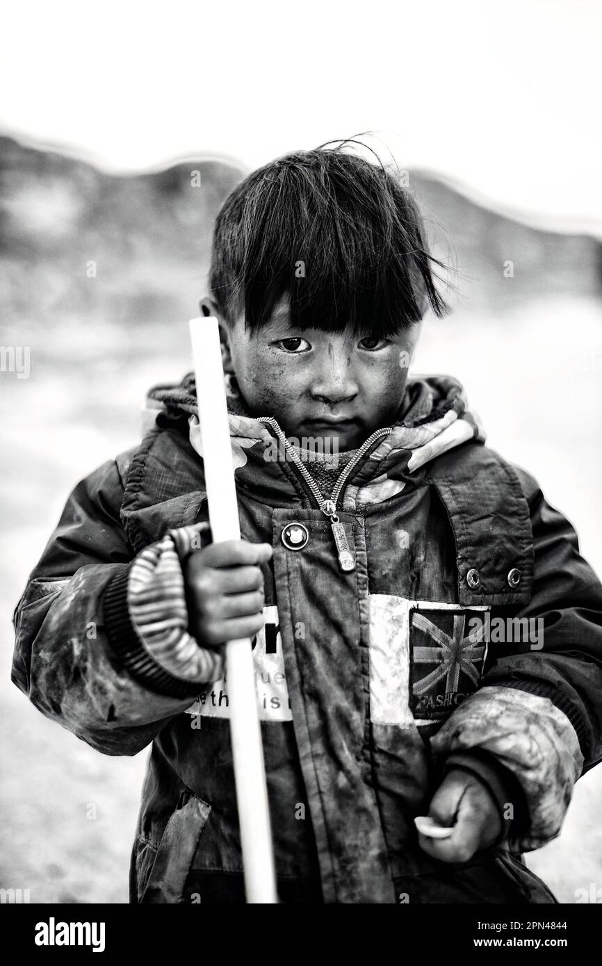 A young shepherd boy in a mountain village in Tibet, China Stock Photo ...