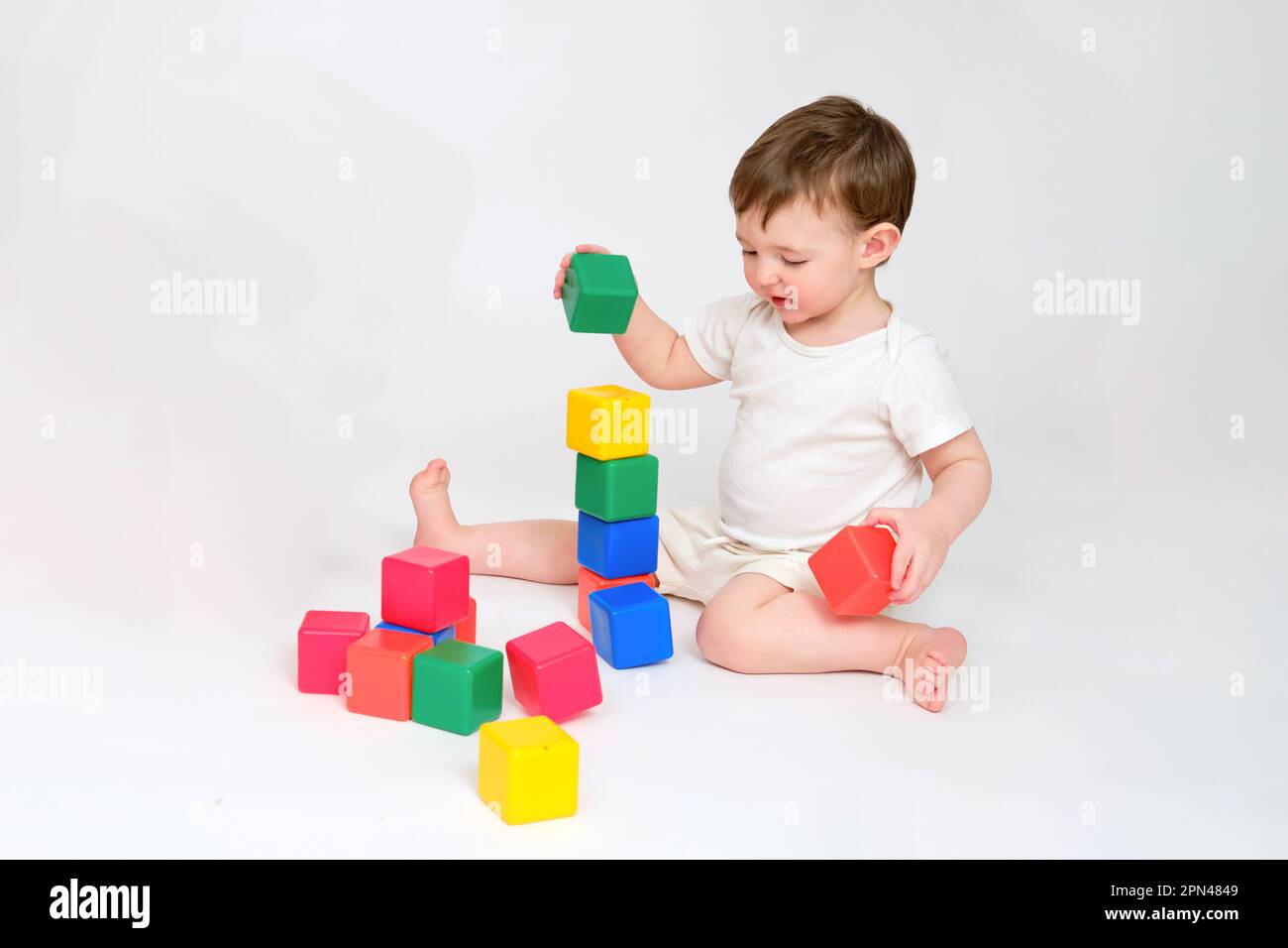 Happy baby play educational toys on studio white background. Portrait ...