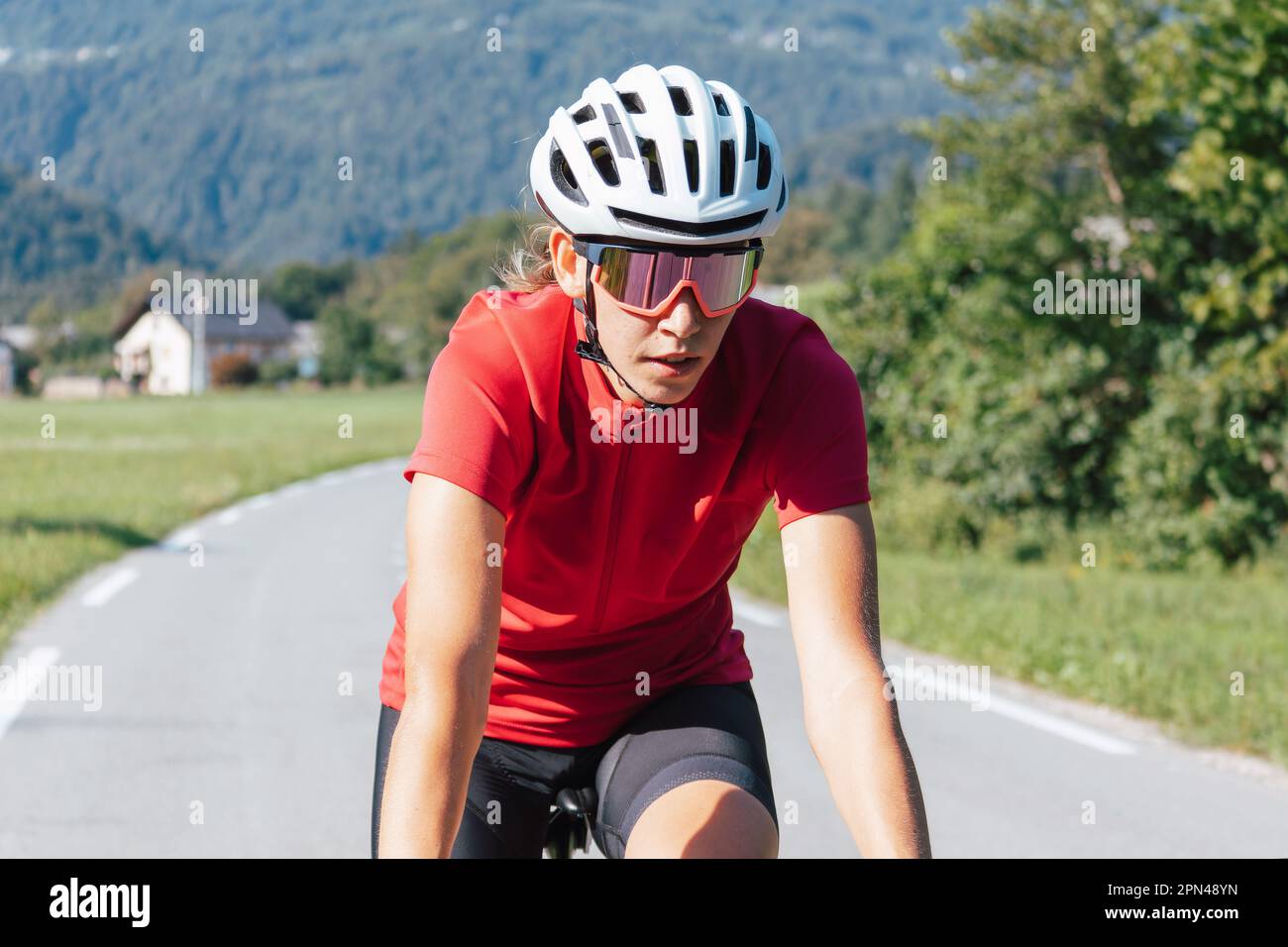 Caucasian girl cyclist with professional racing sports gear riding on ...