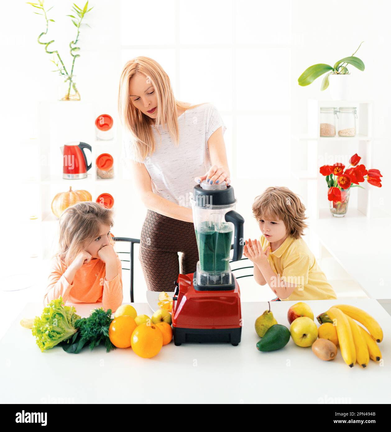 Mother cook with children daughter and son on kitchen, take fun with ...