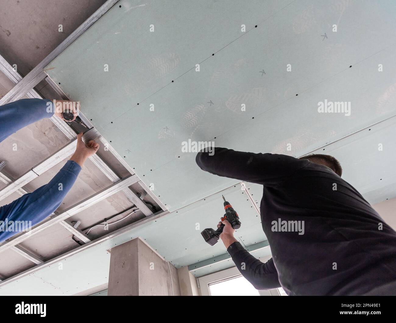 Man assembles profile metal frame for plasterboard ceilings Stock Photo ...