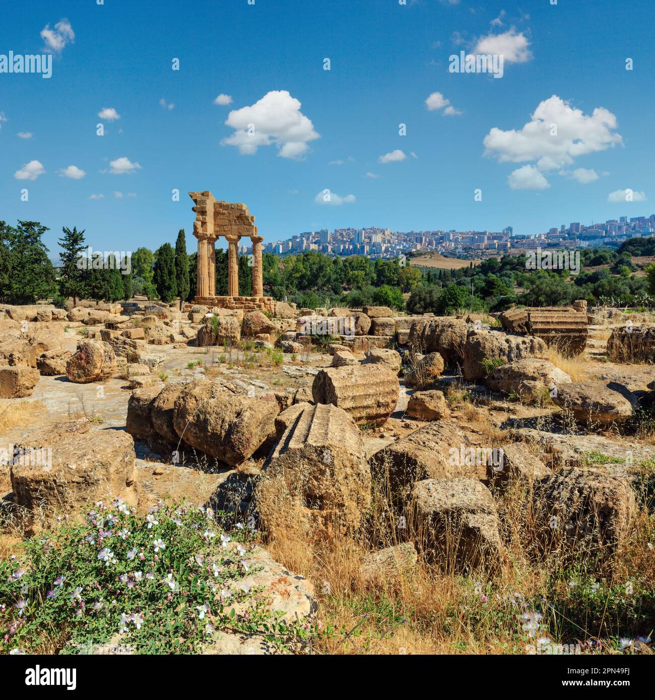 Temple of Dioscuri (Castor and Pollux) with Agrigento town in the ...