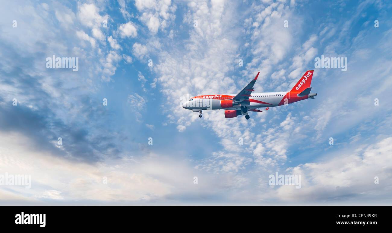 Easyjet aeroplane flying in sky with landing gear down towrards ...