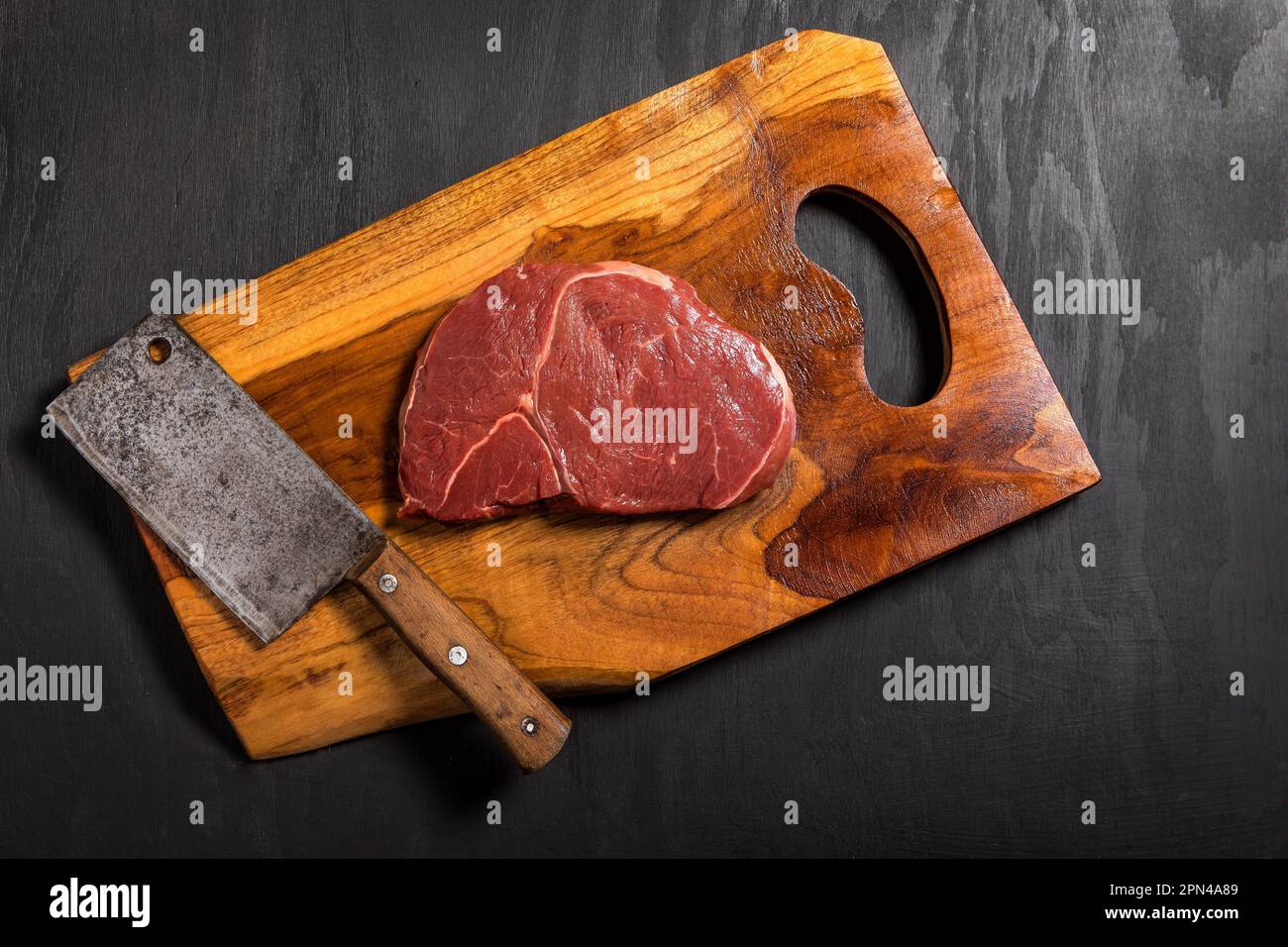 Raw rump beef cut or top sirloin meat steak on butcher table. Black ...