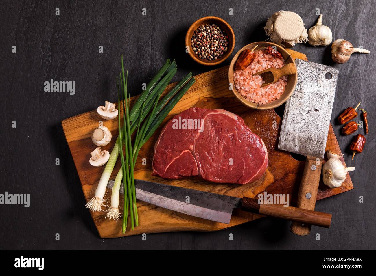 Raw rump beef cut or top sirloin meat steak on butcher table. Black ...